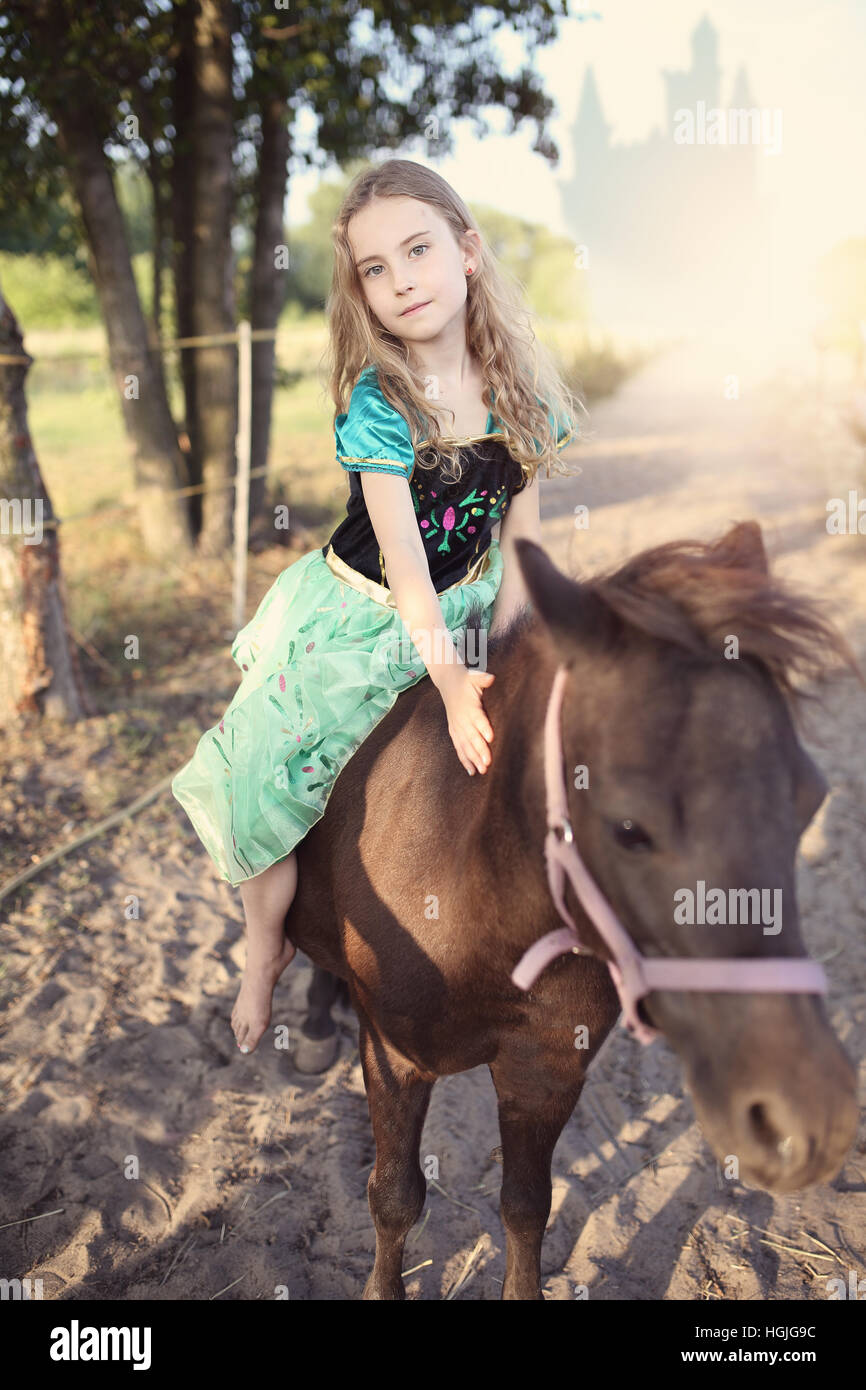Little Princess on horseback in the fairy tale Stock Photo - Alamy