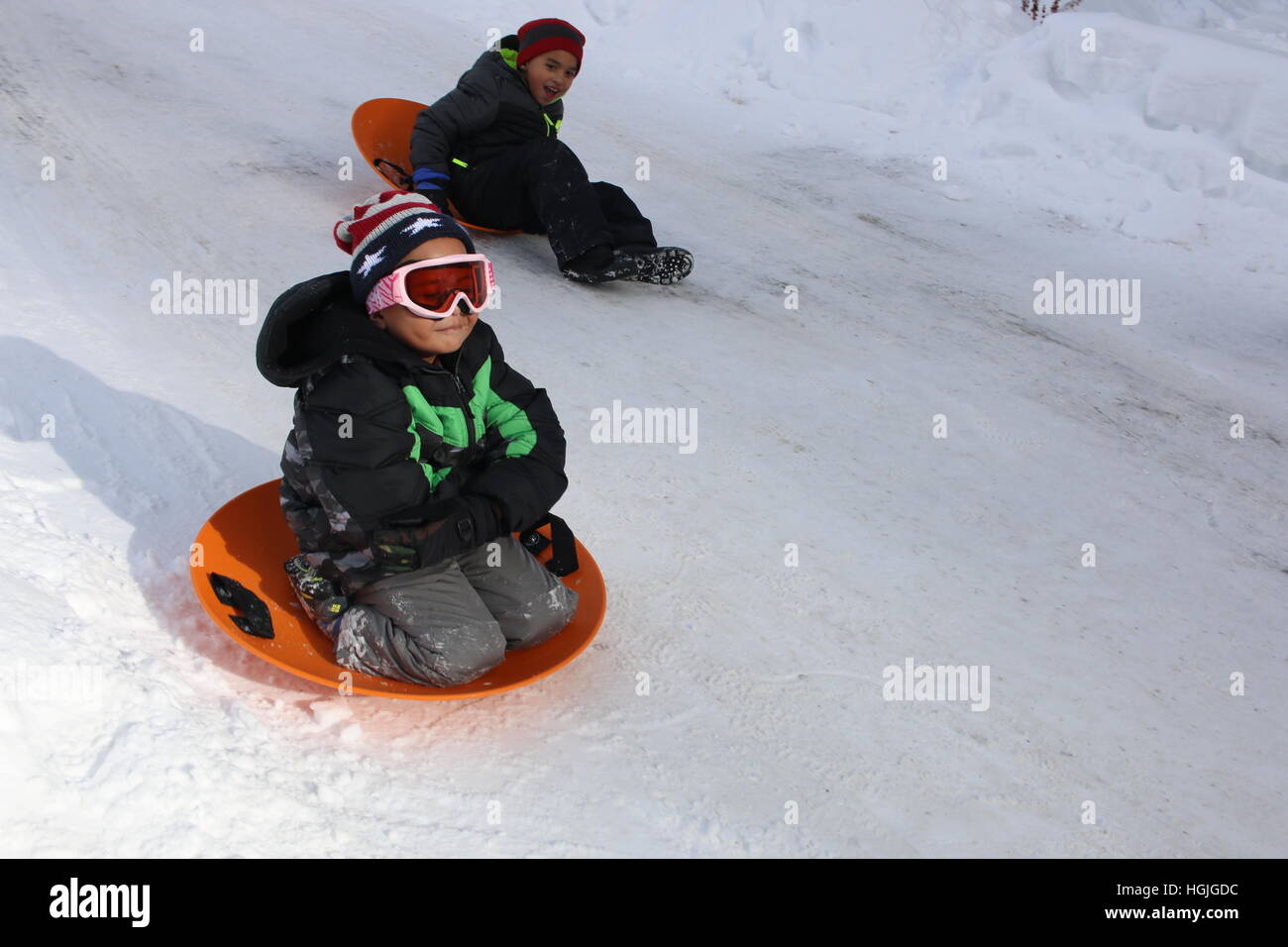 Kids on snow slide hi-res stock photography and images - Alamy