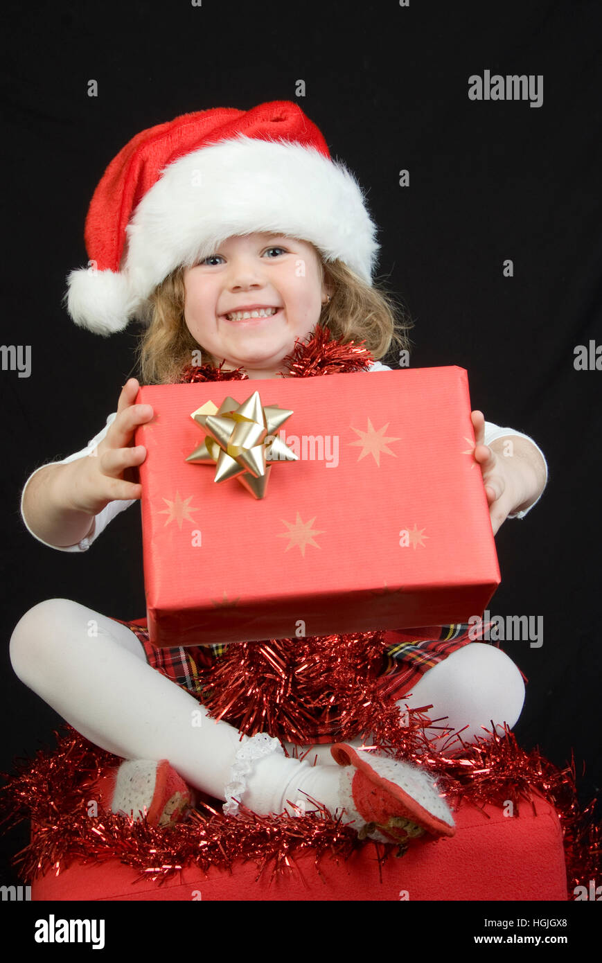 Christmas girl with present Stock Photo - Alamy