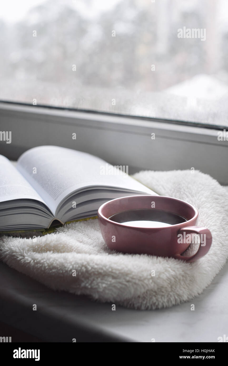 Cozy home still life: cup of hot coffee and opened book with warm plaid ...