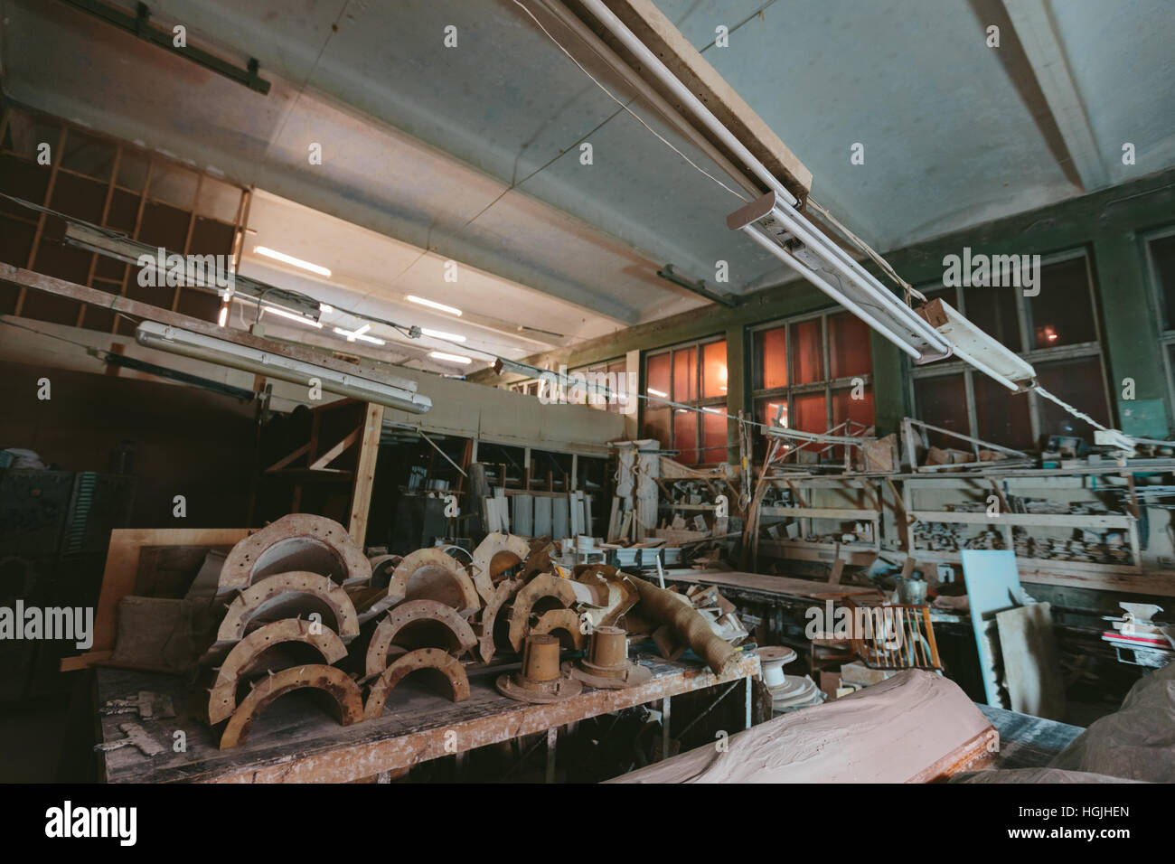 Factory for Production of plaster molds. cluttered dusty old warehouse ...