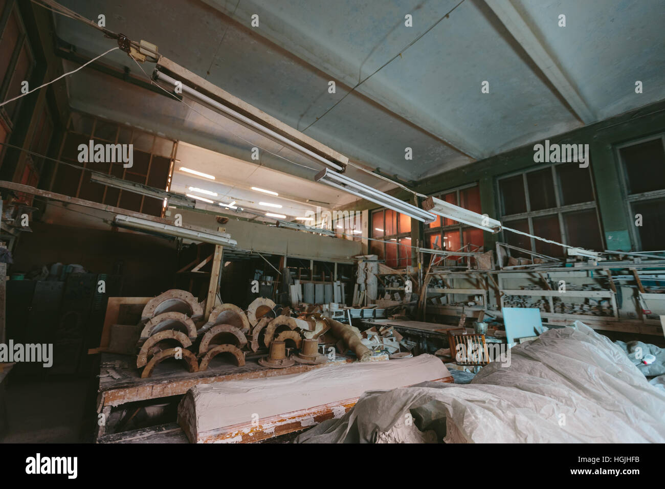 Factory for Production of plaster molds. cluttered dusty old warehouse ...