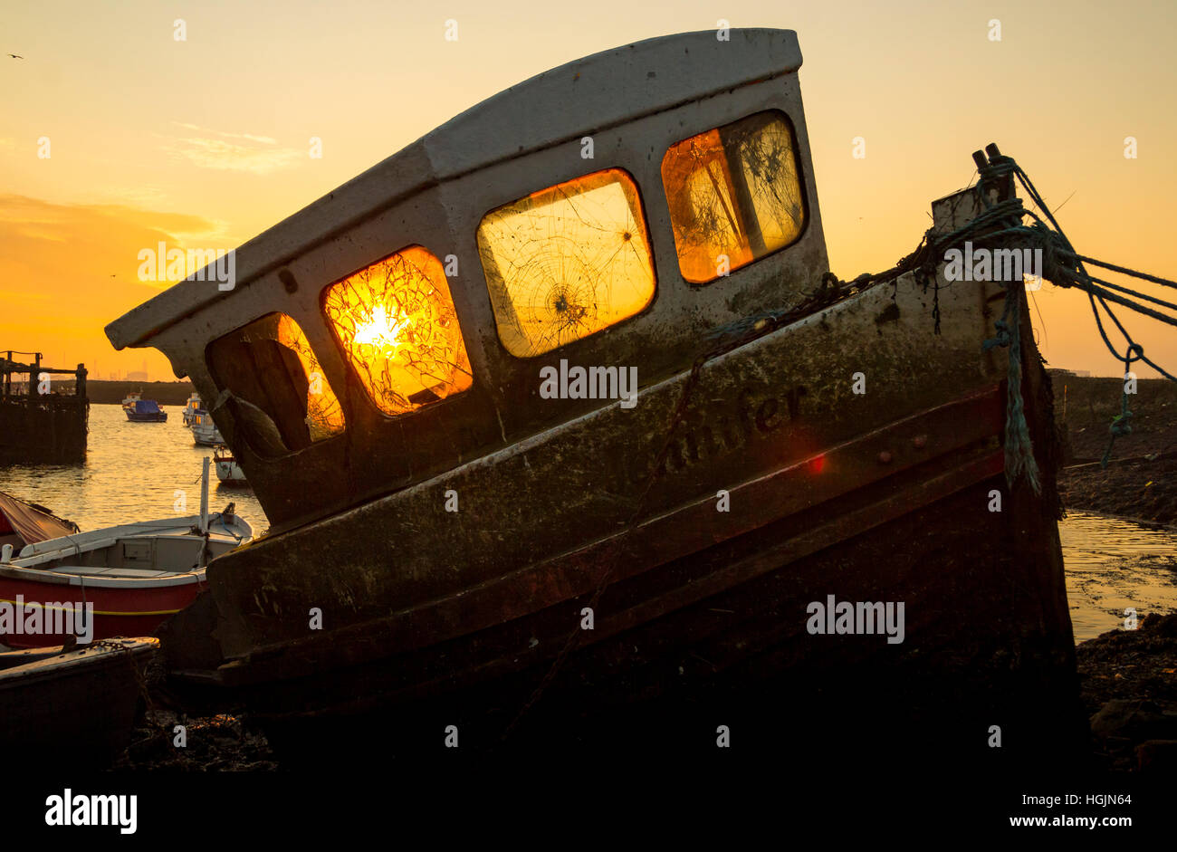 Sun setting through cracked boat window Stock Photo - Alamy
