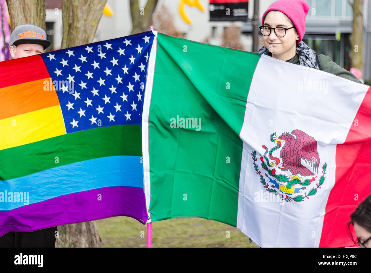 Two young women hold Mexican flag and rainbow US flag in support of ...