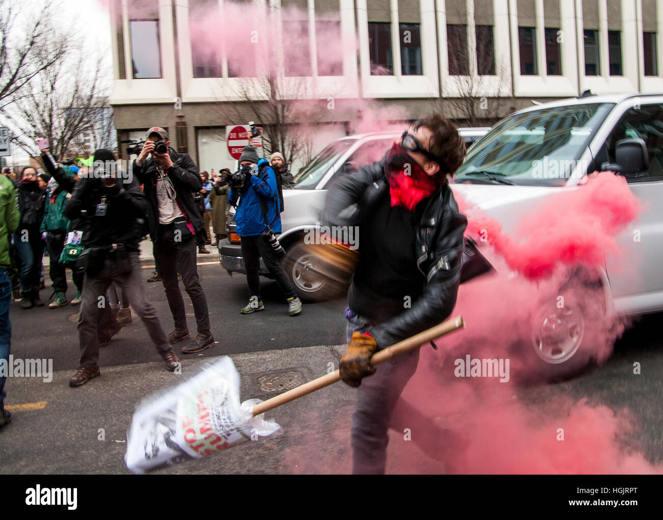 Washington, DC, USA. 20th Jan, 2017. A protestor picks up and a riot ...