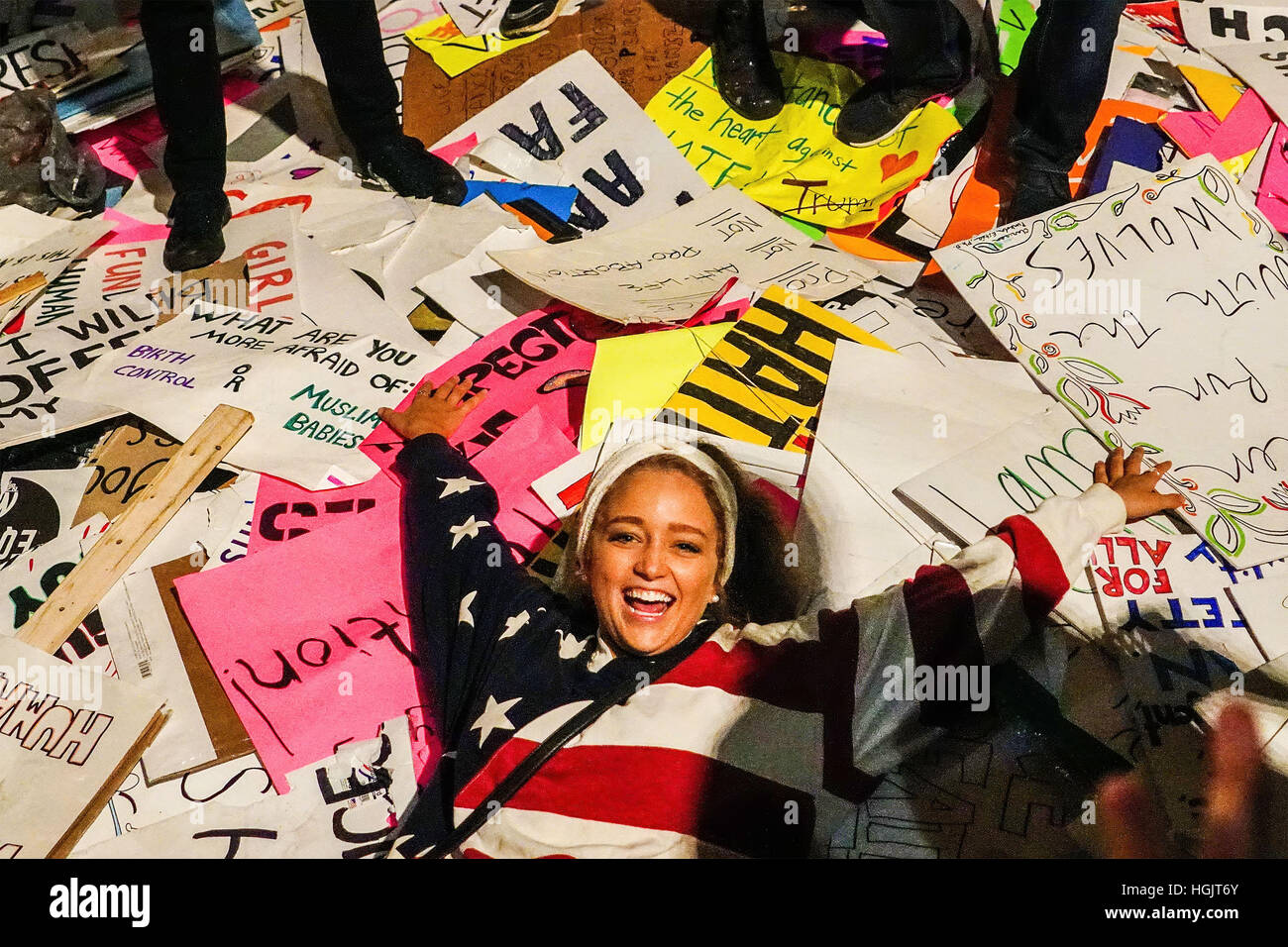 A Donald Trump supporter lies down on top of discarded signs from the ...