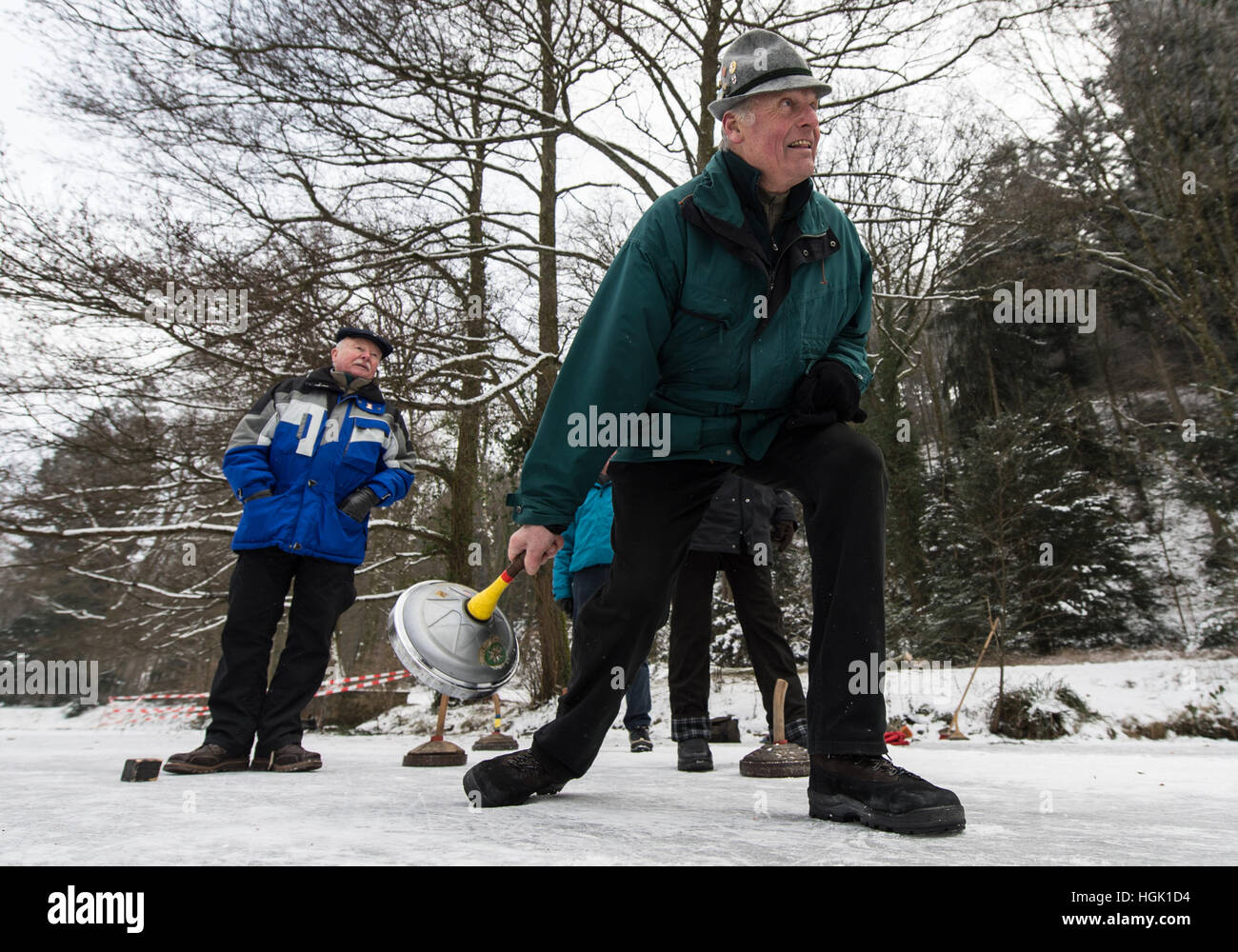 Seniors play Bavarian curling on the frozen Waldsee lake in Freiburg ...