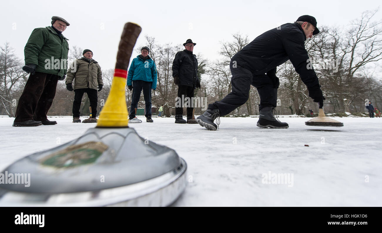 Seniors play Bavarian curling on the frozen Waldsee lake in Freiburg ...