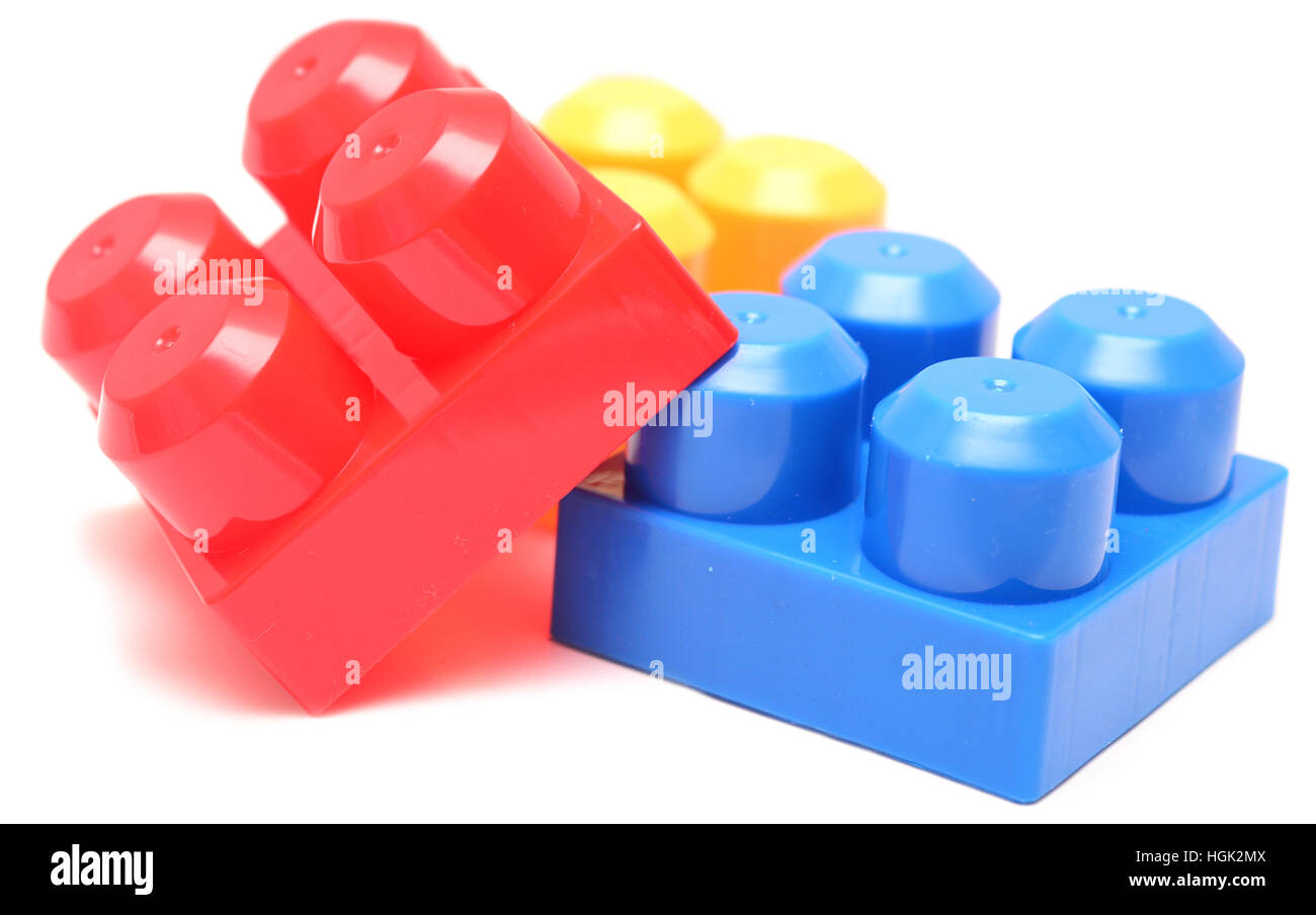 Colorful stacked toy plastic building blocks isolated on white ...