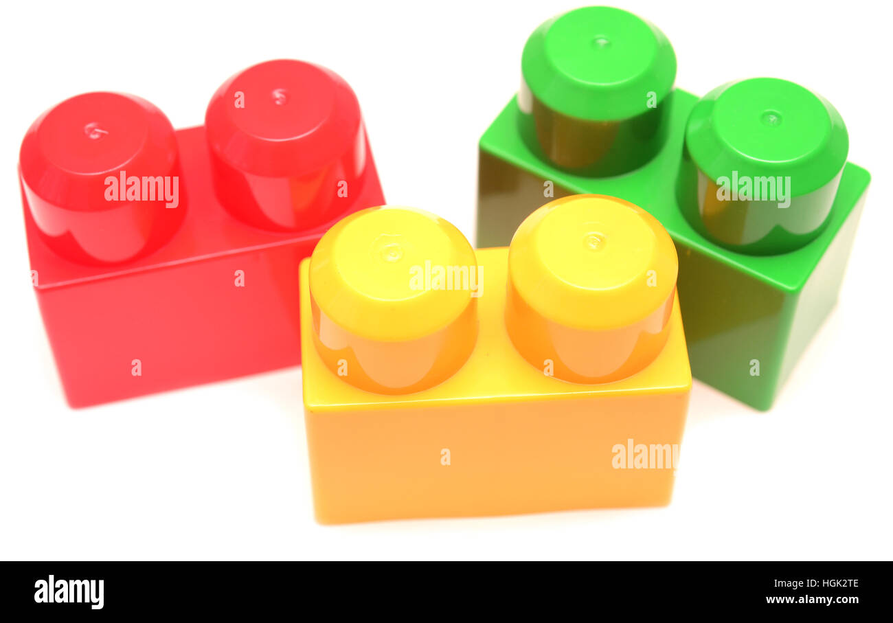 Colorful stacked toy plastic building blocks isolated on white ...