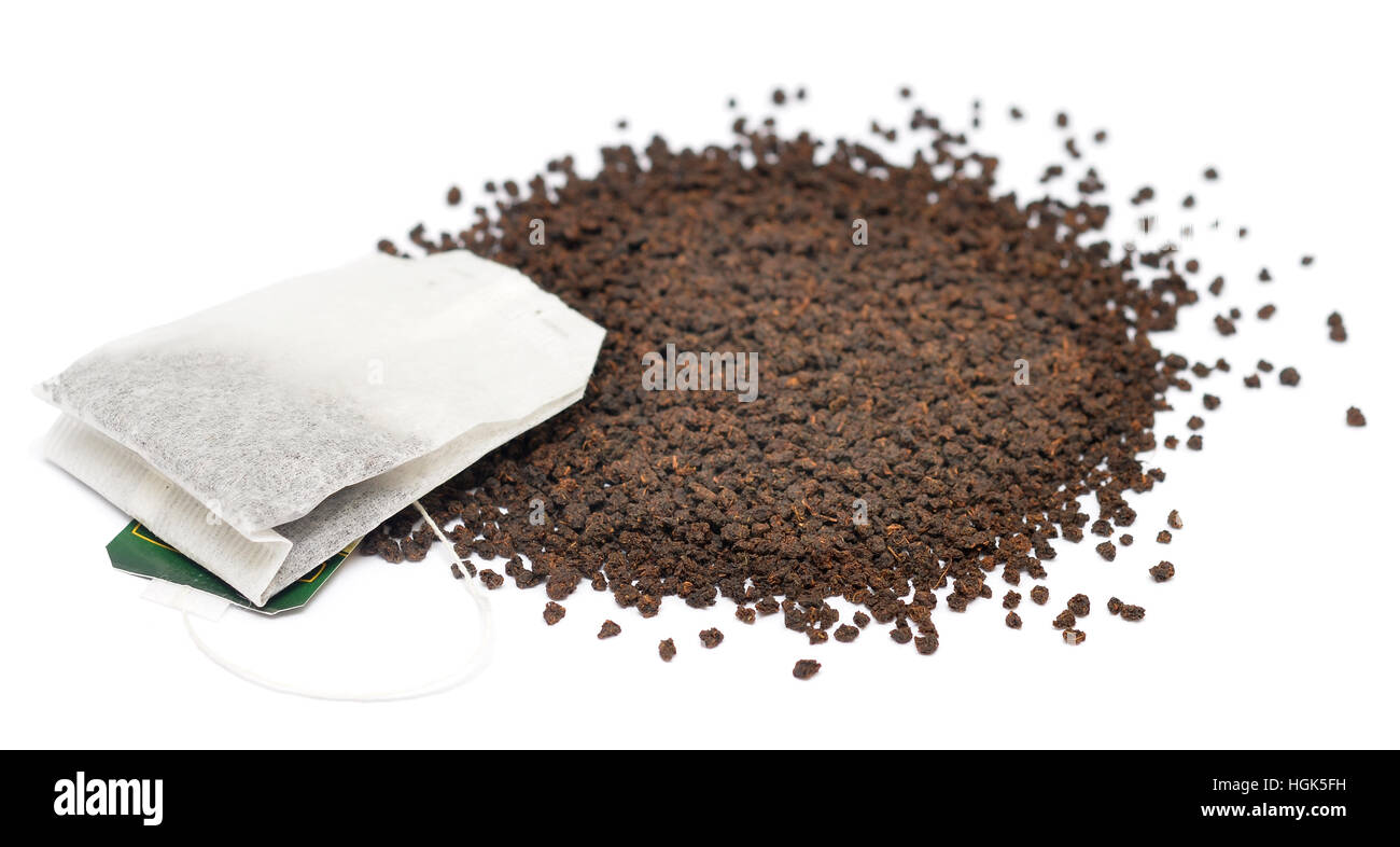 Tea bag on pile of black tea granulates on white Stock Photo - Alamy