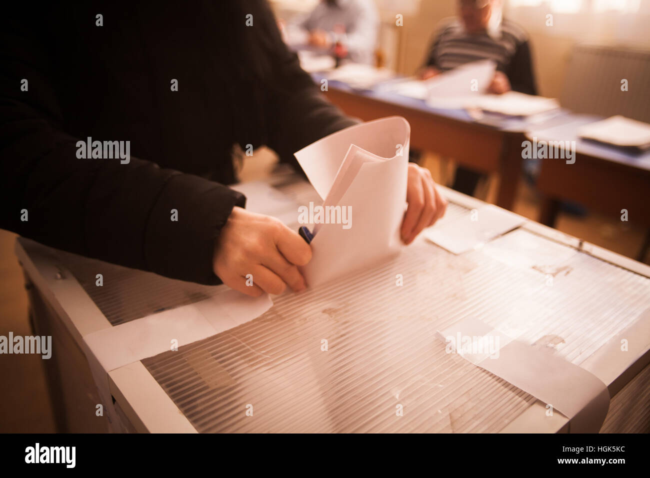 A person casts her ballot during voting for parliamentary elections at ...