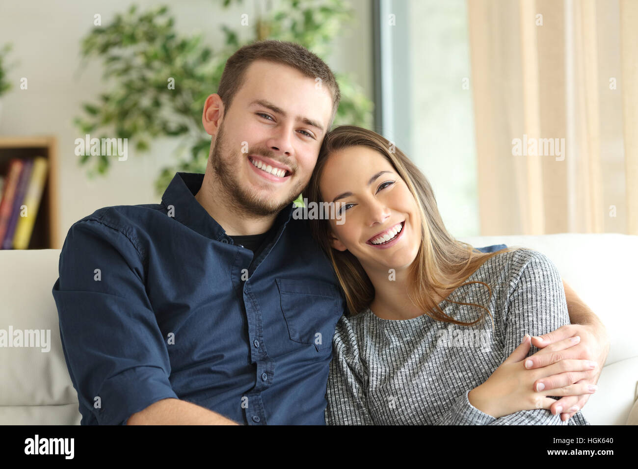 Front view portrait of a happy couple posing and looking at camera ...