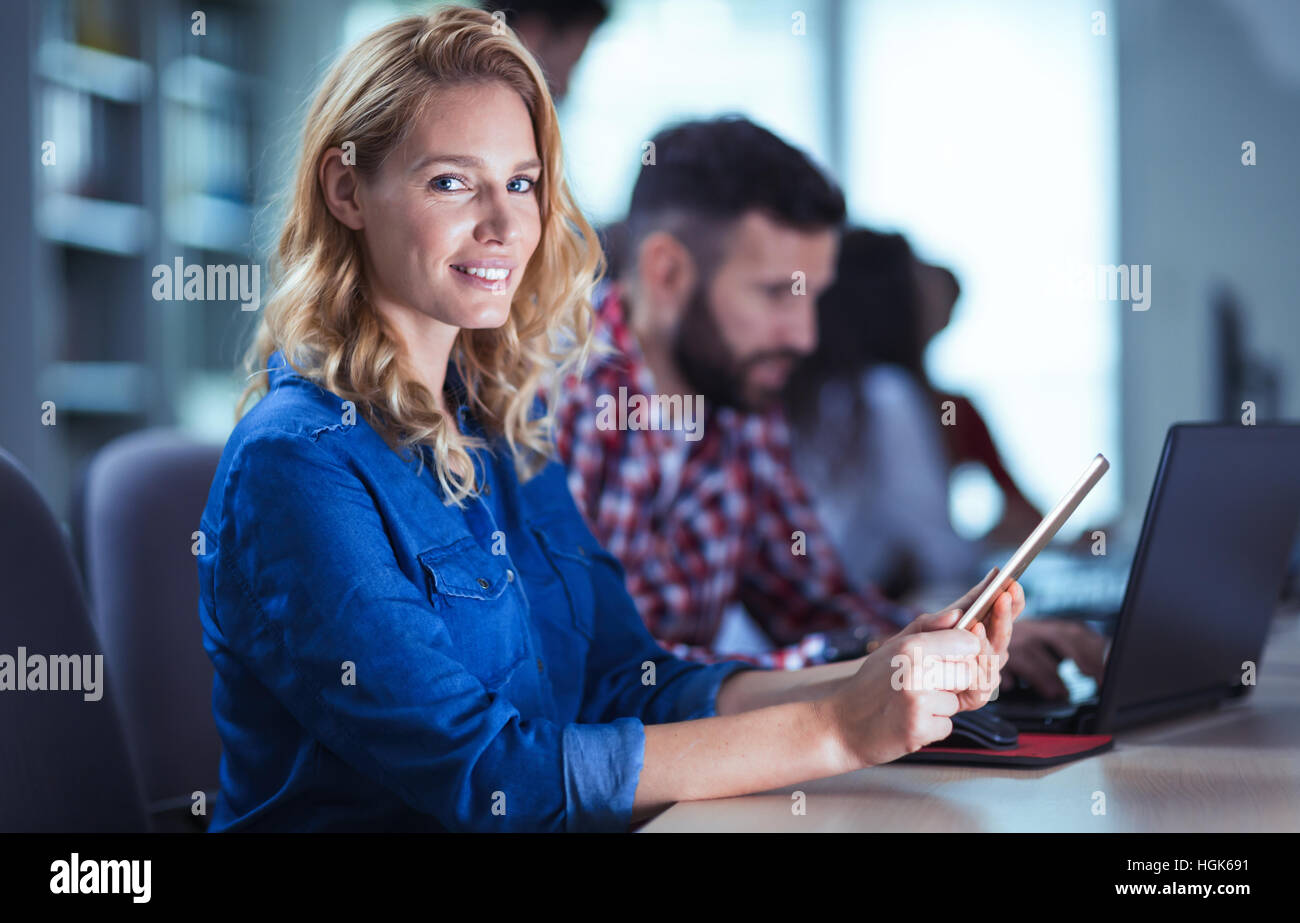 Blonde woman working at information technology developing company Stock ...