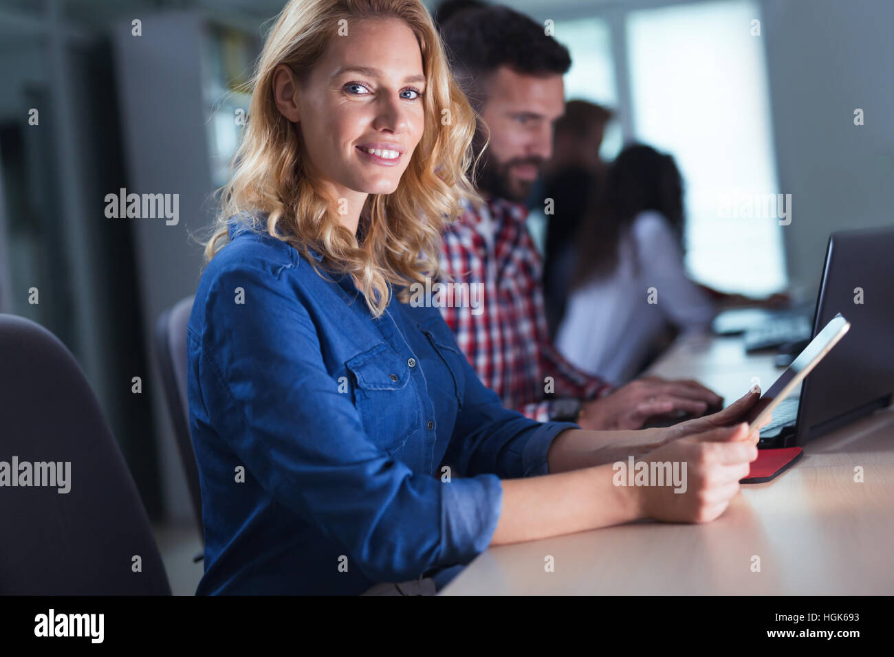 Blond woman working at information technology developing company Stock ...