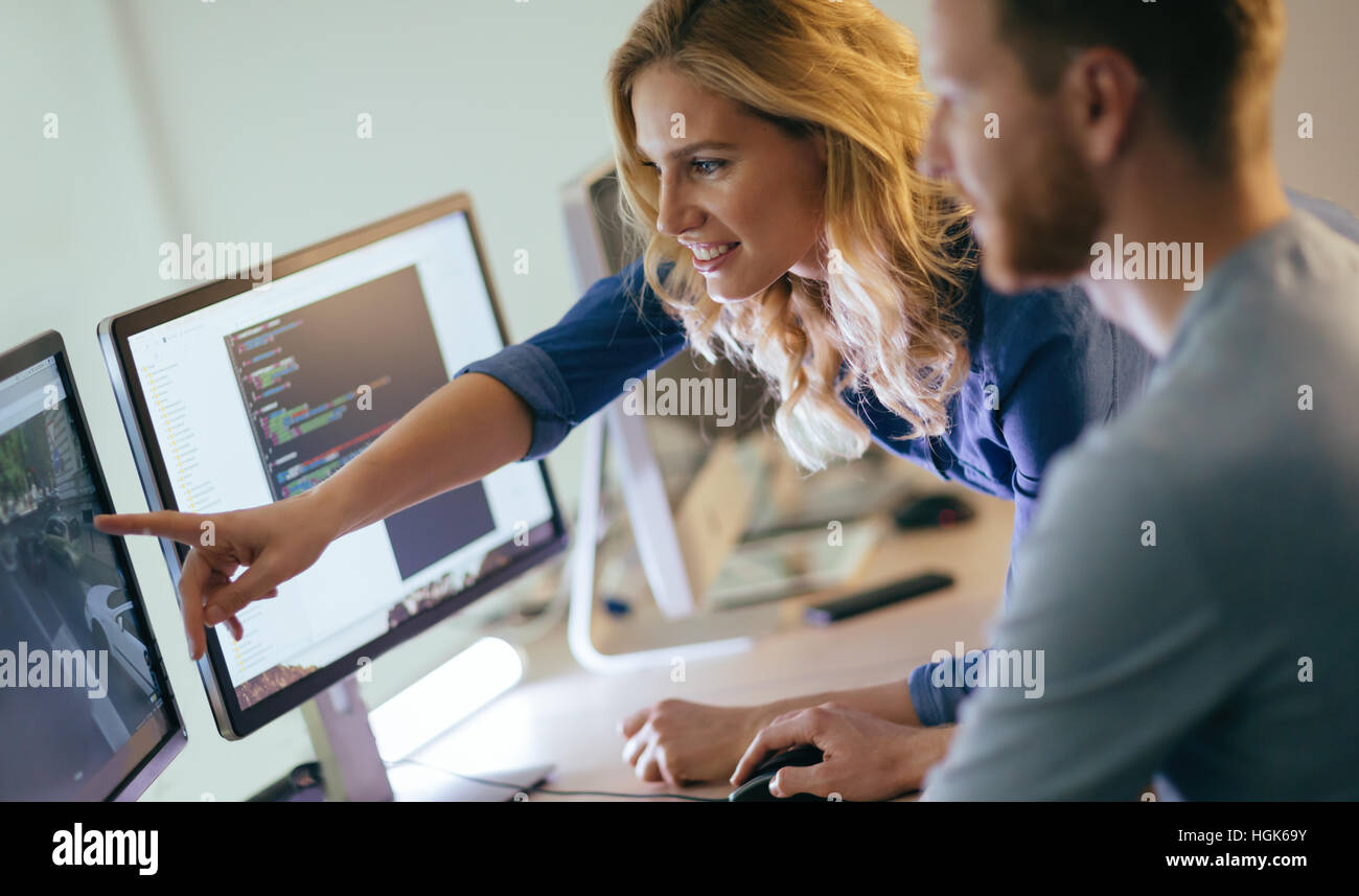 Programmers cooperating at IT company developing apps Stock Photo - Alamy