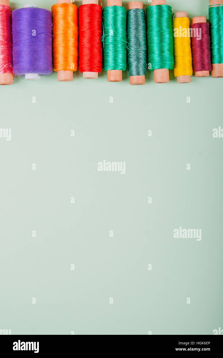 Colorful threads on a green background for craft and getting creative ...