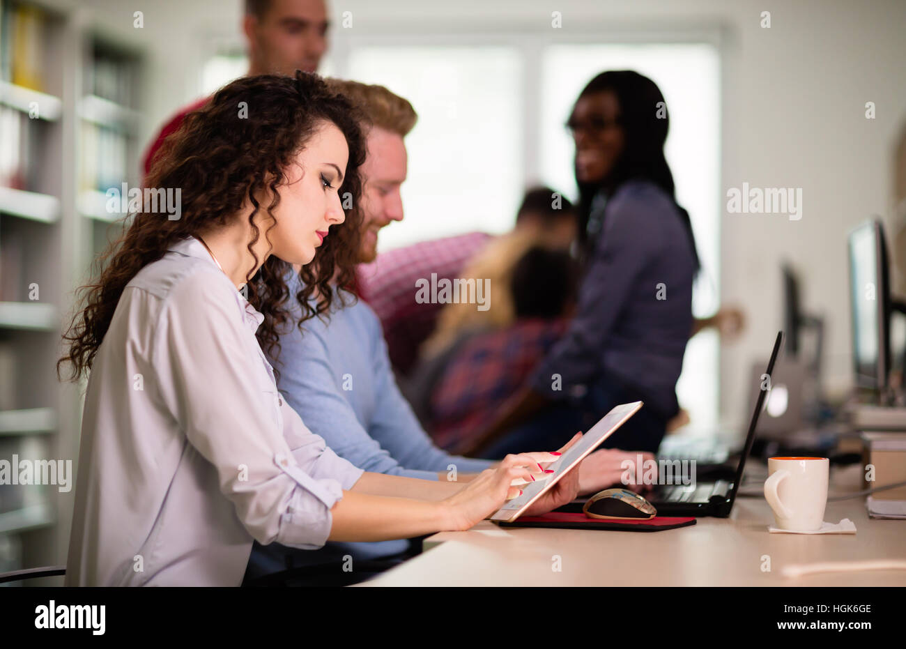 Programmers and business people collaborating in company office Stock ...