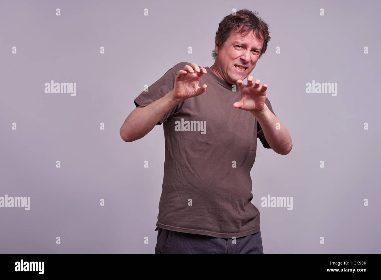 A middle aged man standing and feeling scared Stock Photo - Alamy