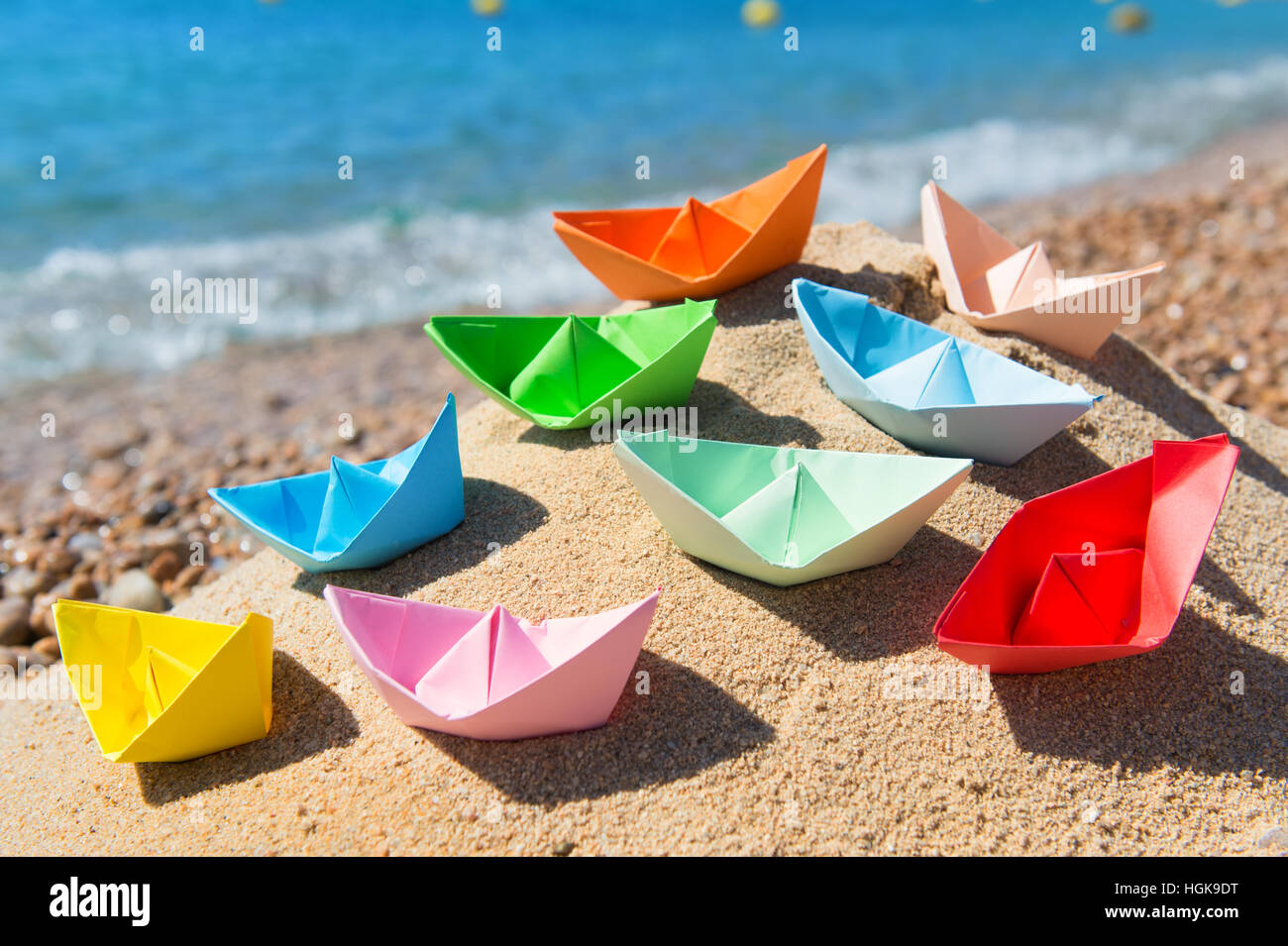 Paper boats in the sand at the beach Stock Photo - Alamy