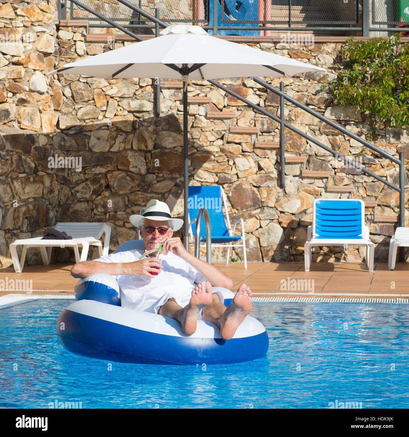 wealthy man relaxing in own swimming pool Stock Photo - Alamy