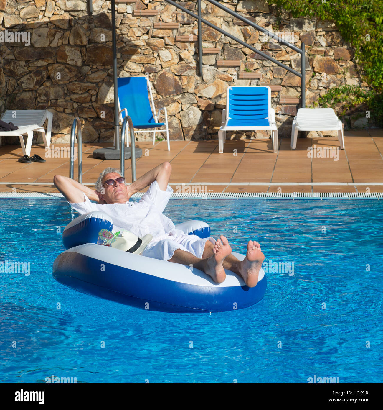 wealthy man relaxing in own swimming pool Stock Photo - Alamy