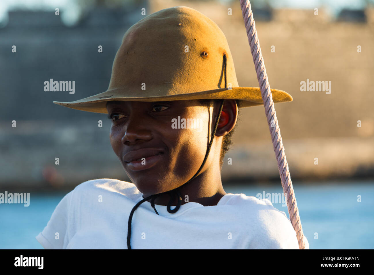 Young man on a dhow in front of the fort, Mozambique Island (Ilha de ...