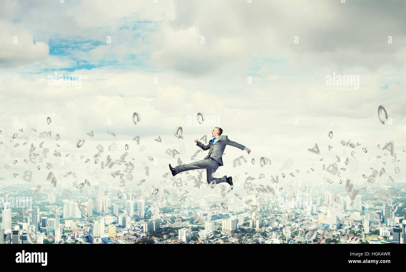 Businessman jumping high Stock Photo - Alamy