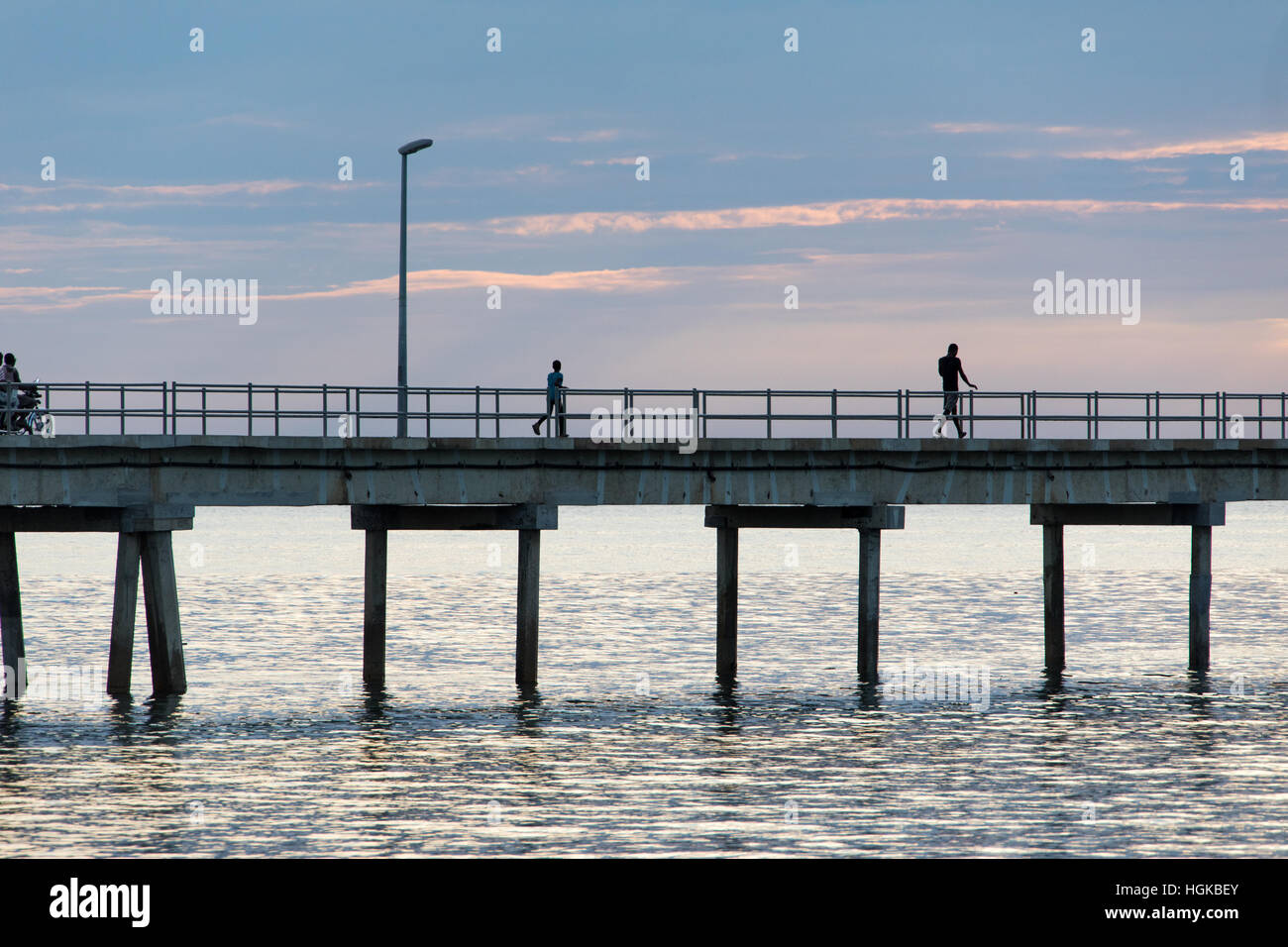 Boy running to catch up to a man walking on the 2 mile Bridge to ...
