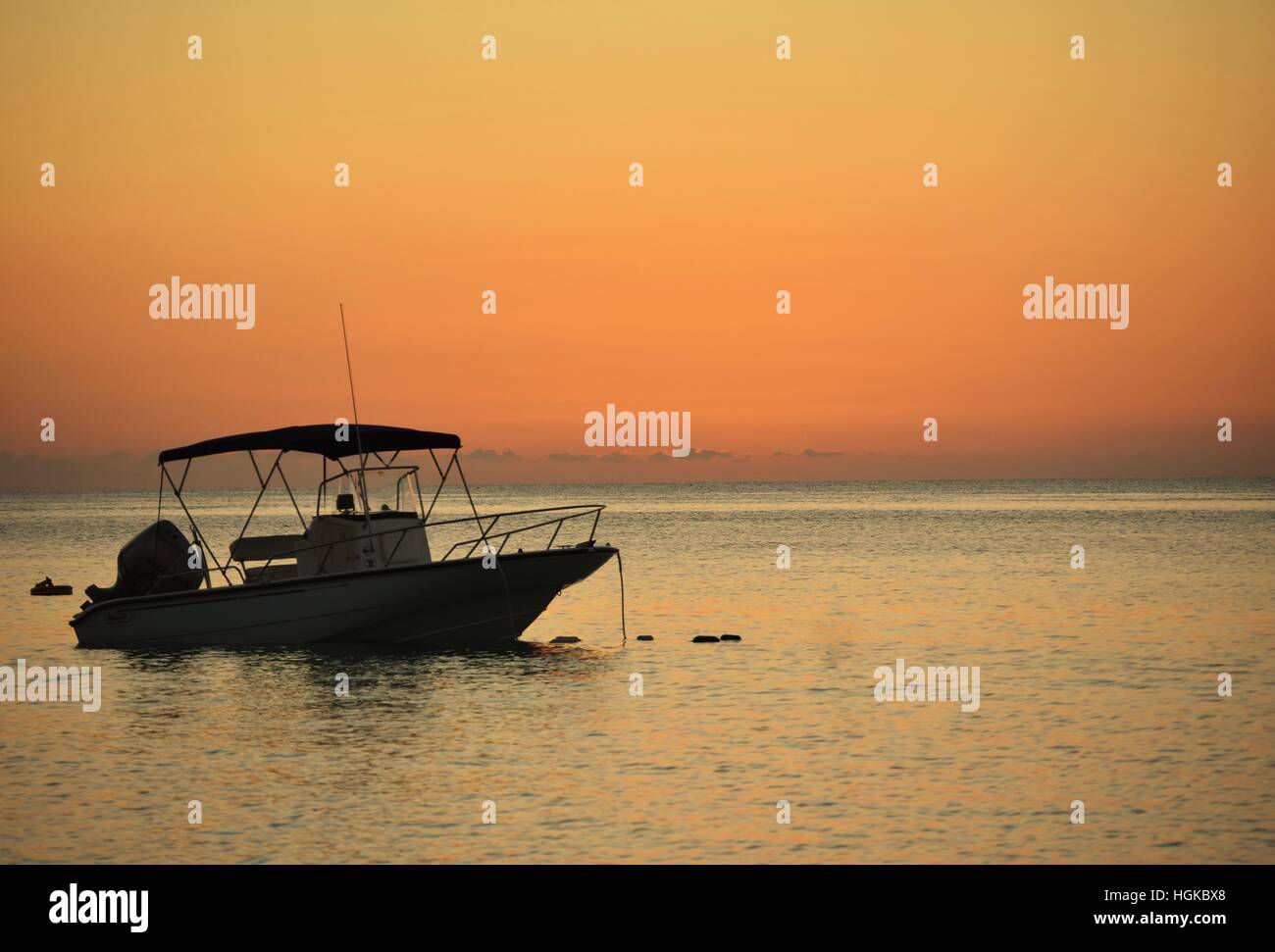boat on the ocean at sunset Stock Photo - Alamy