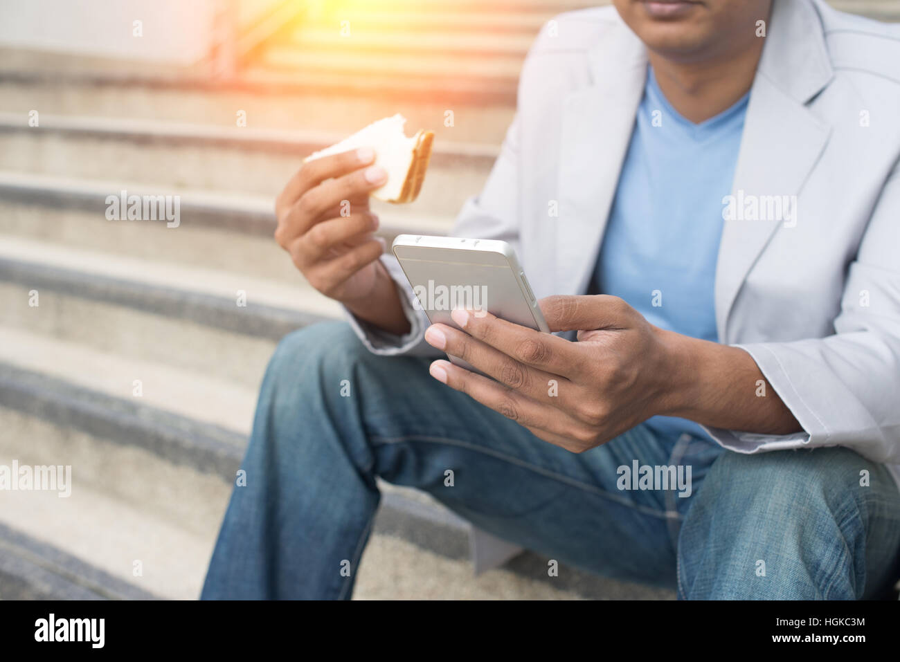 indian business male eating bread Stock Photo - Alamy