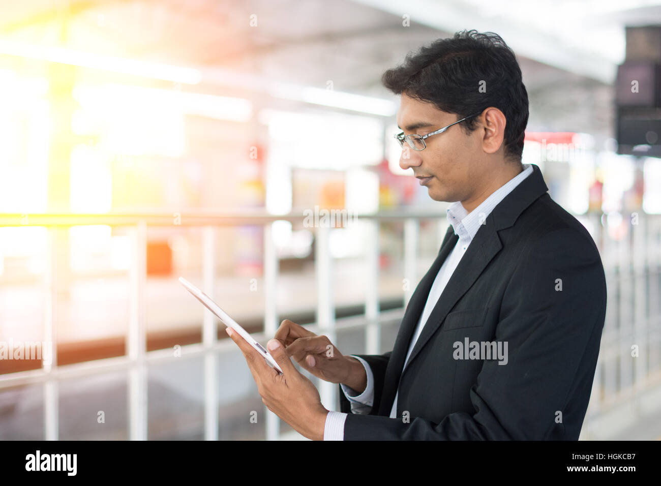 indian male using tablet Stock Photo - Alamy