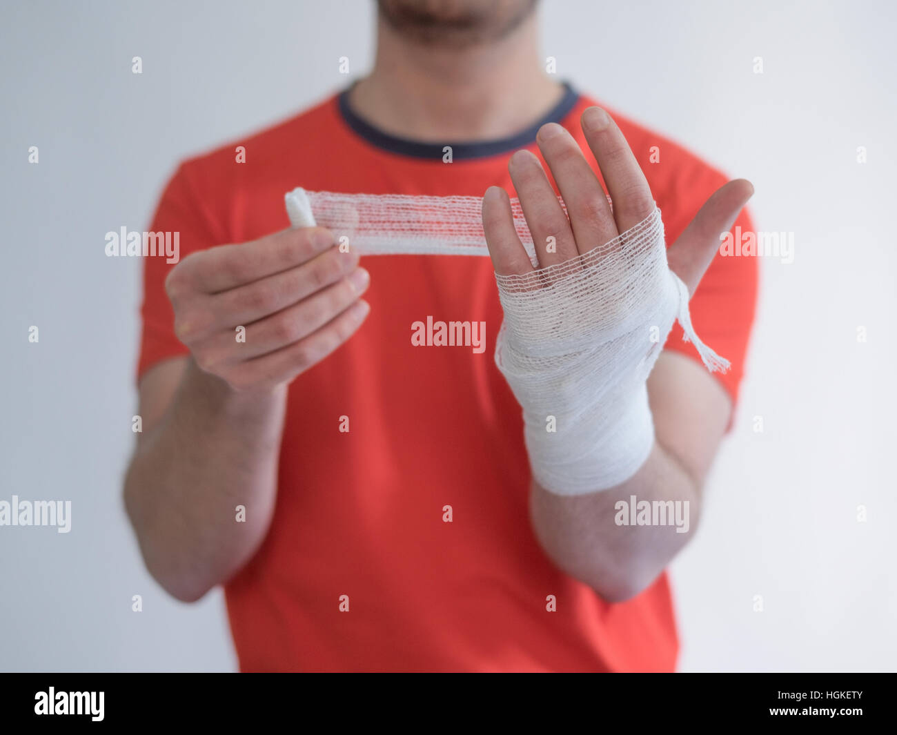 Sport man with bandages medication on his hand suffering after a sport ...
