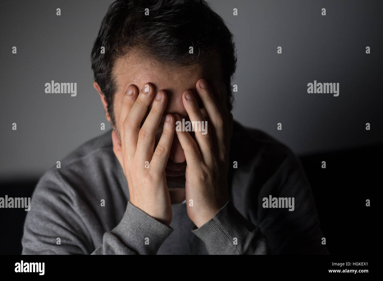 Portrait of thoughtful sad man alone in the dark Stock Photo - Alamy