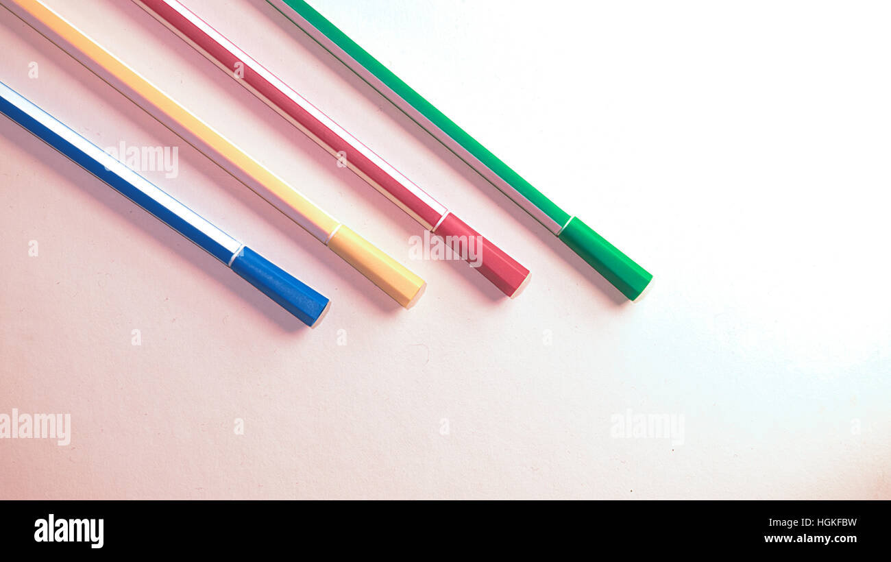 Four color pens on a white background laying in a row Stock Photo - Alamy