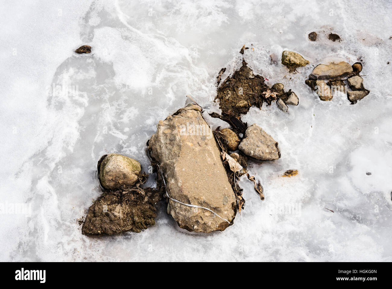 Rocks covered in ice on a river Stock Photo - Alamy