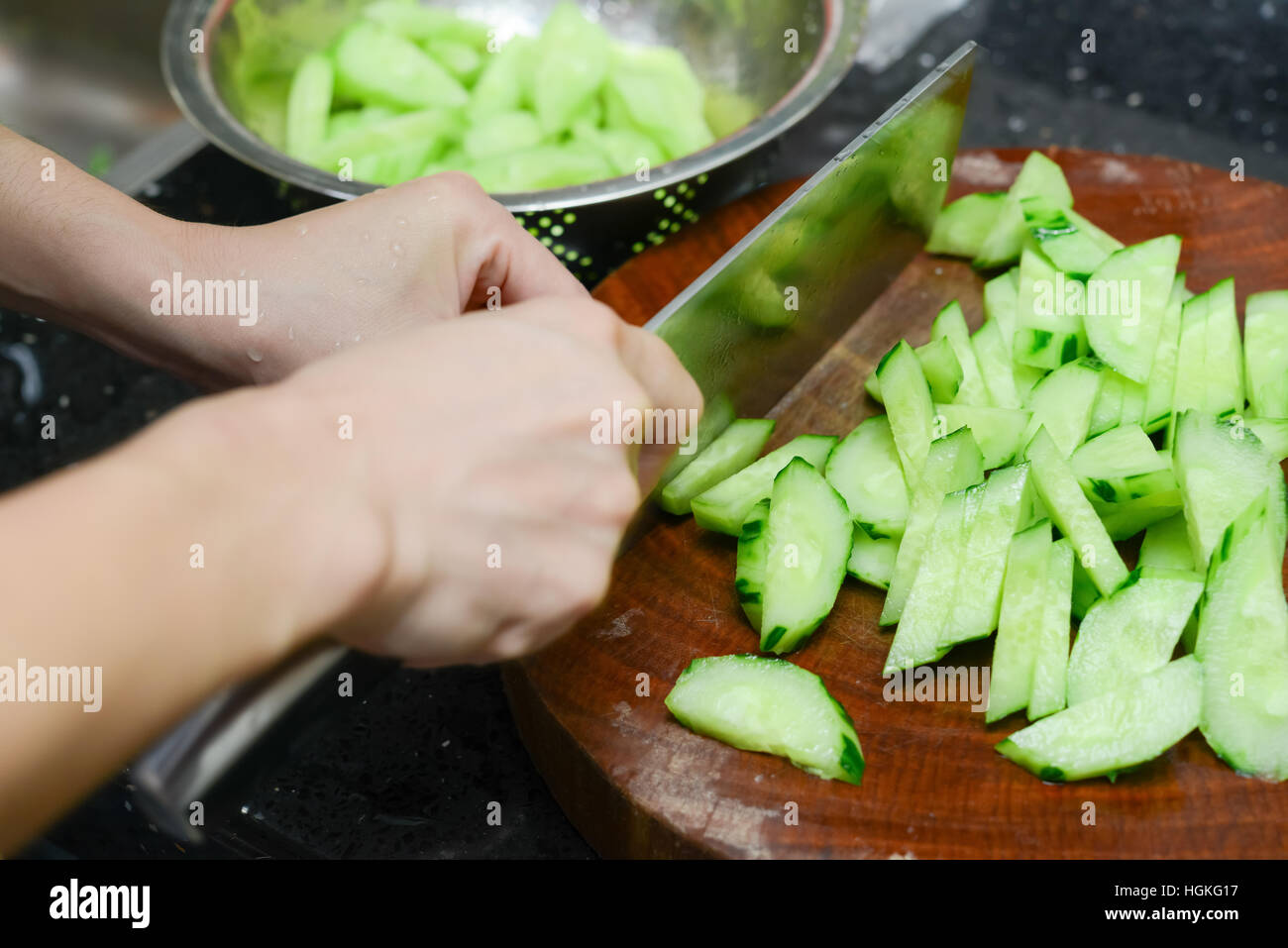lady preparing cucumber slices on a wooden chop board Stock Photo - Alamy