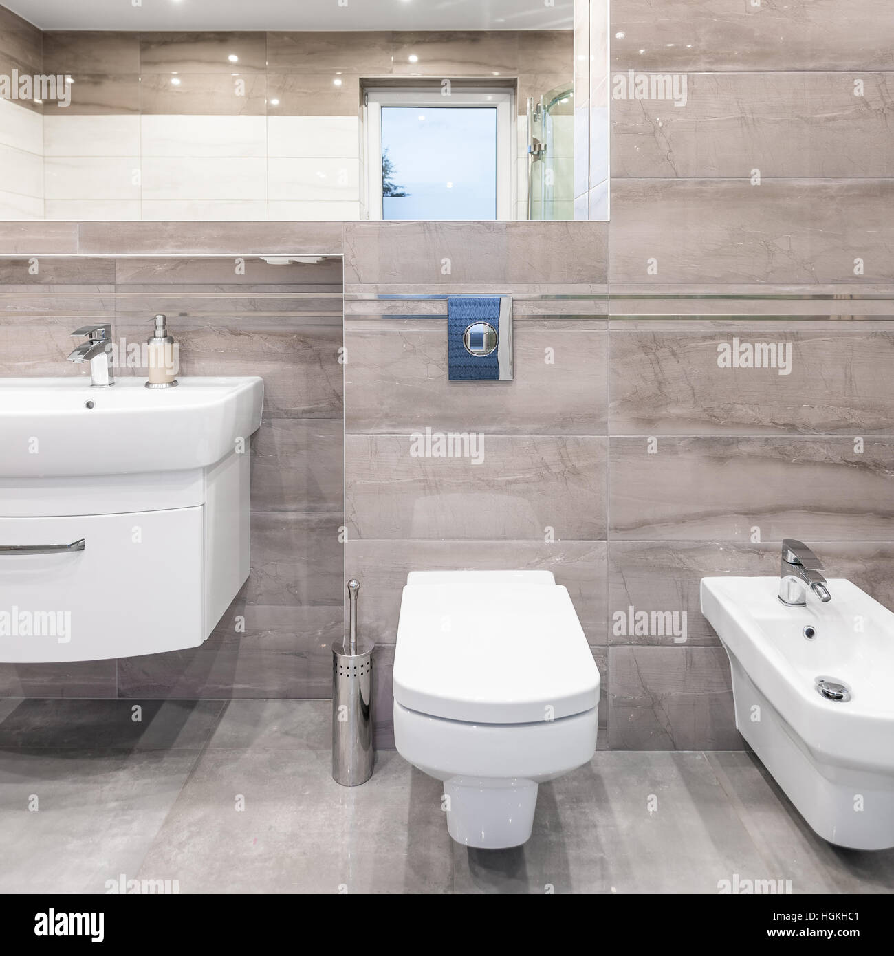 Villa bathroom in beige with toilet, bidet, mirror and basin Stock ...