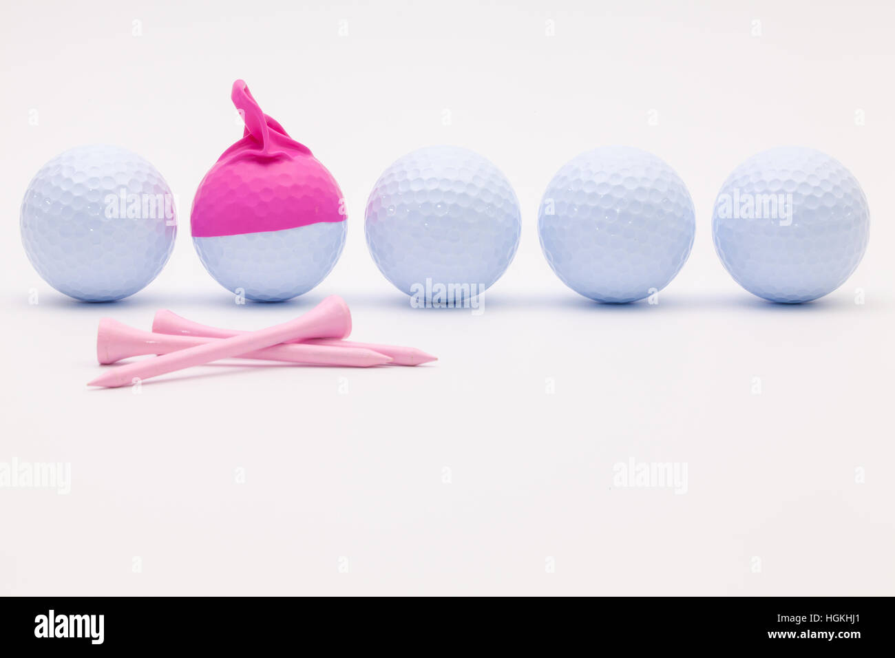 White golf balls with funny cap on the white background. Funny golf ...