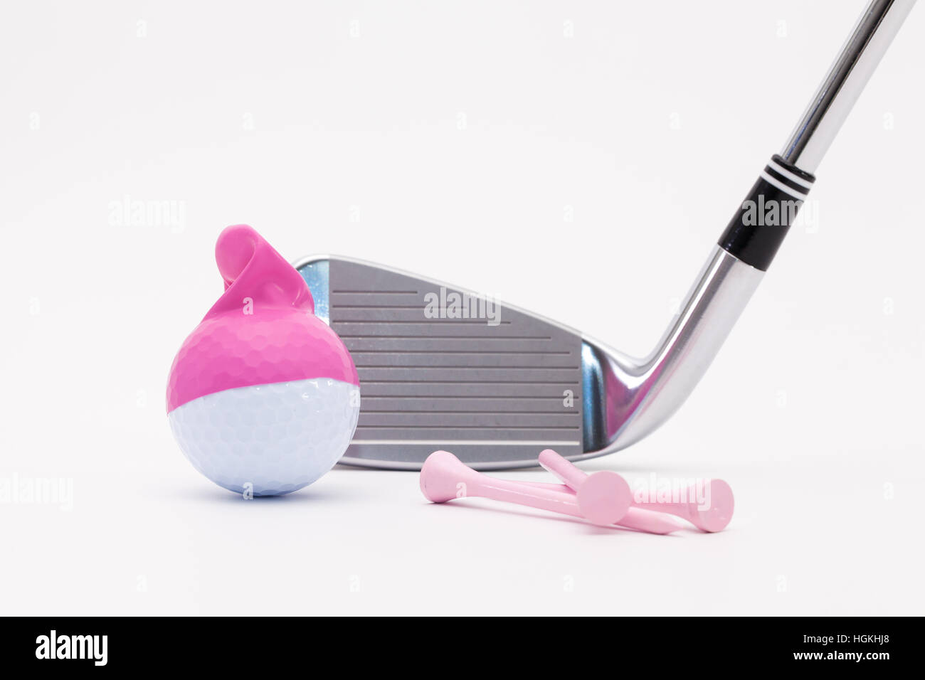 White golf ball with funny cap and golf club on the white background ...