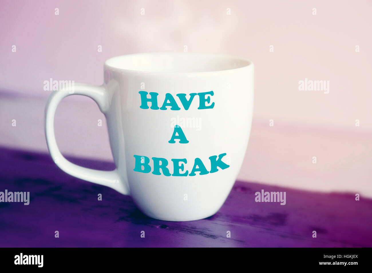 white cup with the words Have A Break on purple wooden table Stock ...