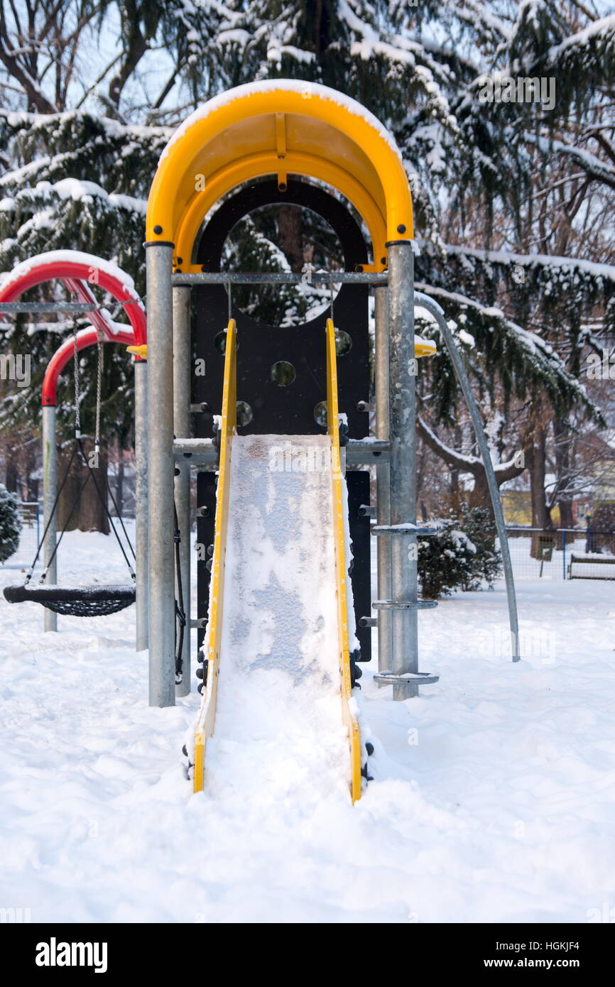 Empty slide in snow covered park on a winter day Stock Photo - Alamy