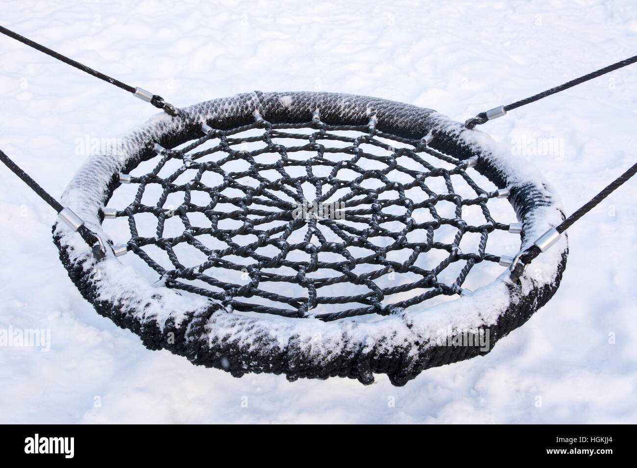 Frozen swing seat in the snowy park Stock Photo - Alamy
