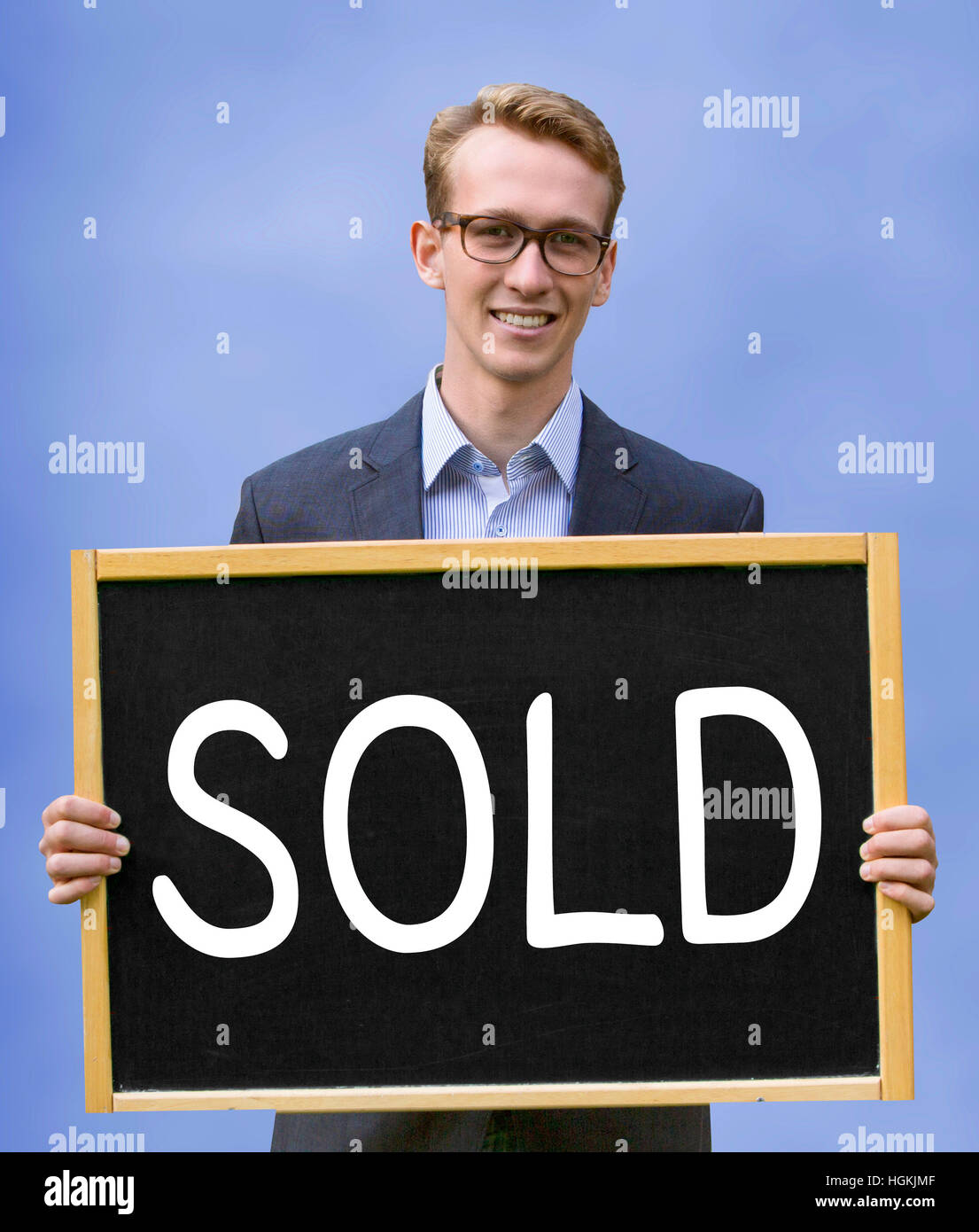 young businessman holding sign with the word Sold Stock Photo - Alamy