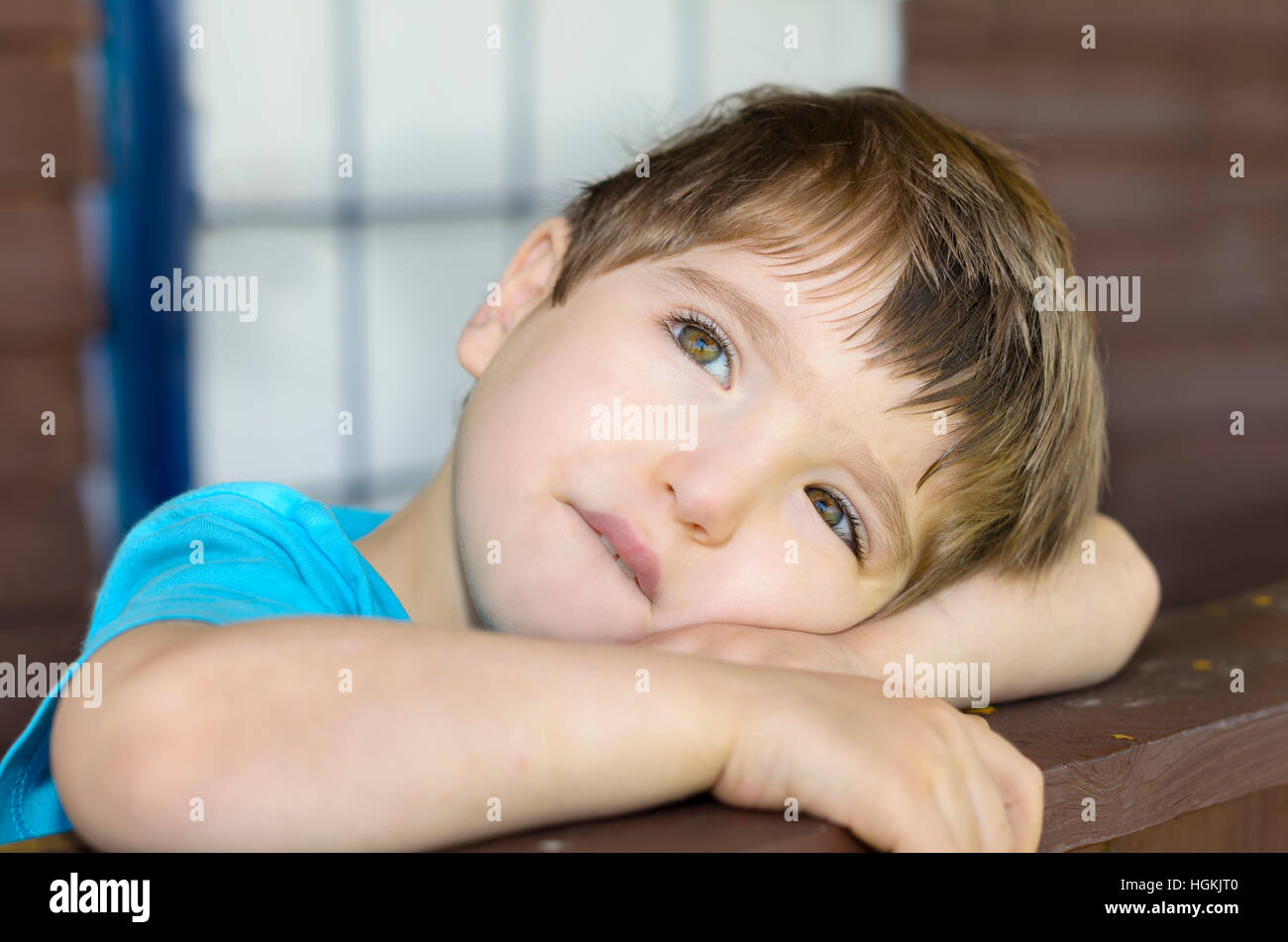 A wistful child on his porch Stock Photo - Alamy