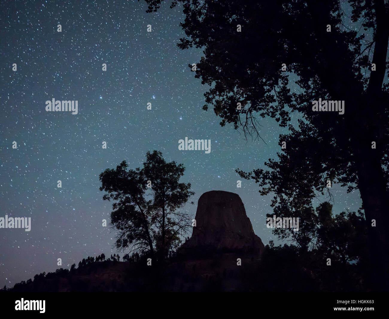 Stars above Devil's Tower with the lights of descending climbers ...