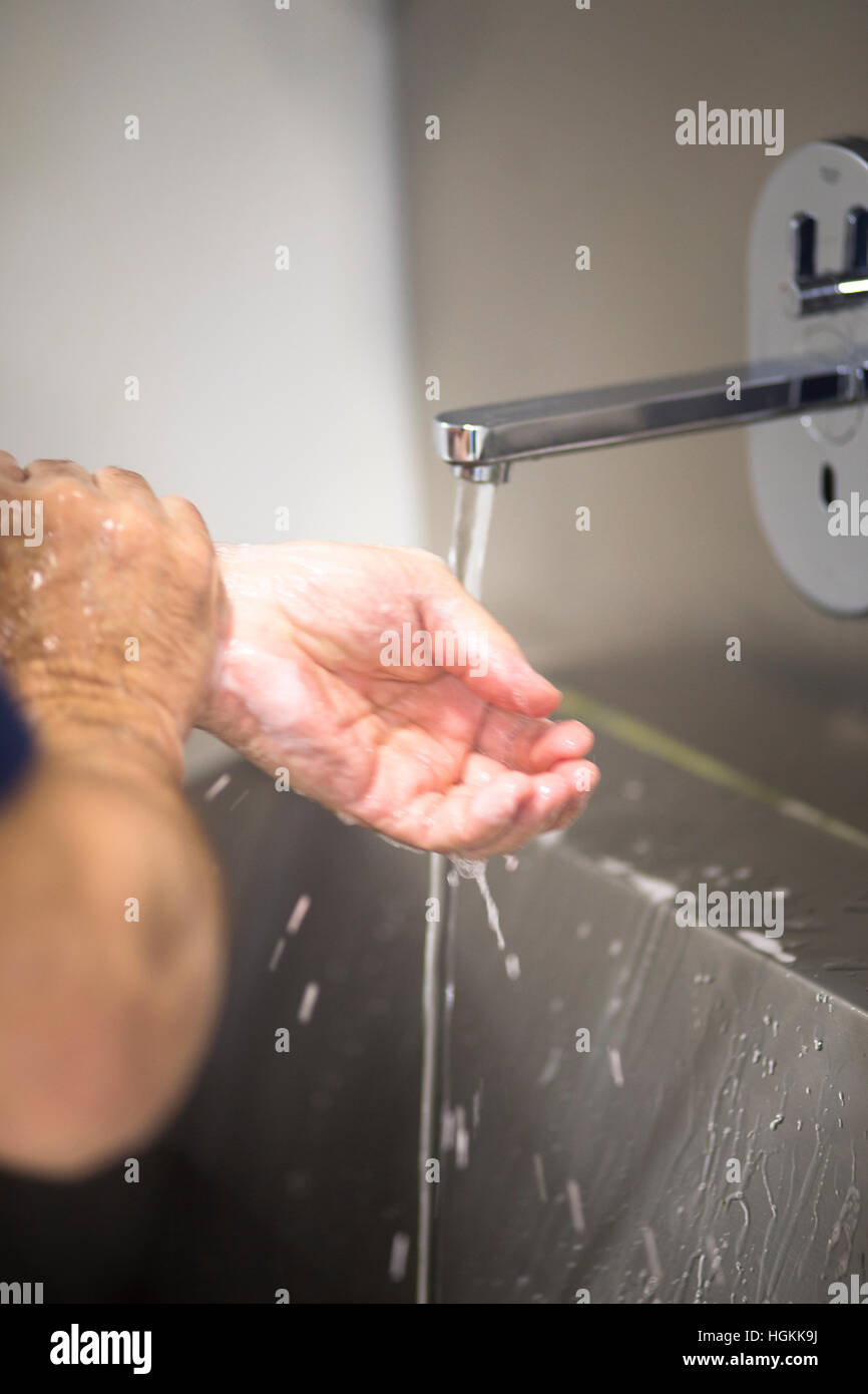 Surgeon in hospital surgery washing handsin sterile uniform "scrubs ...