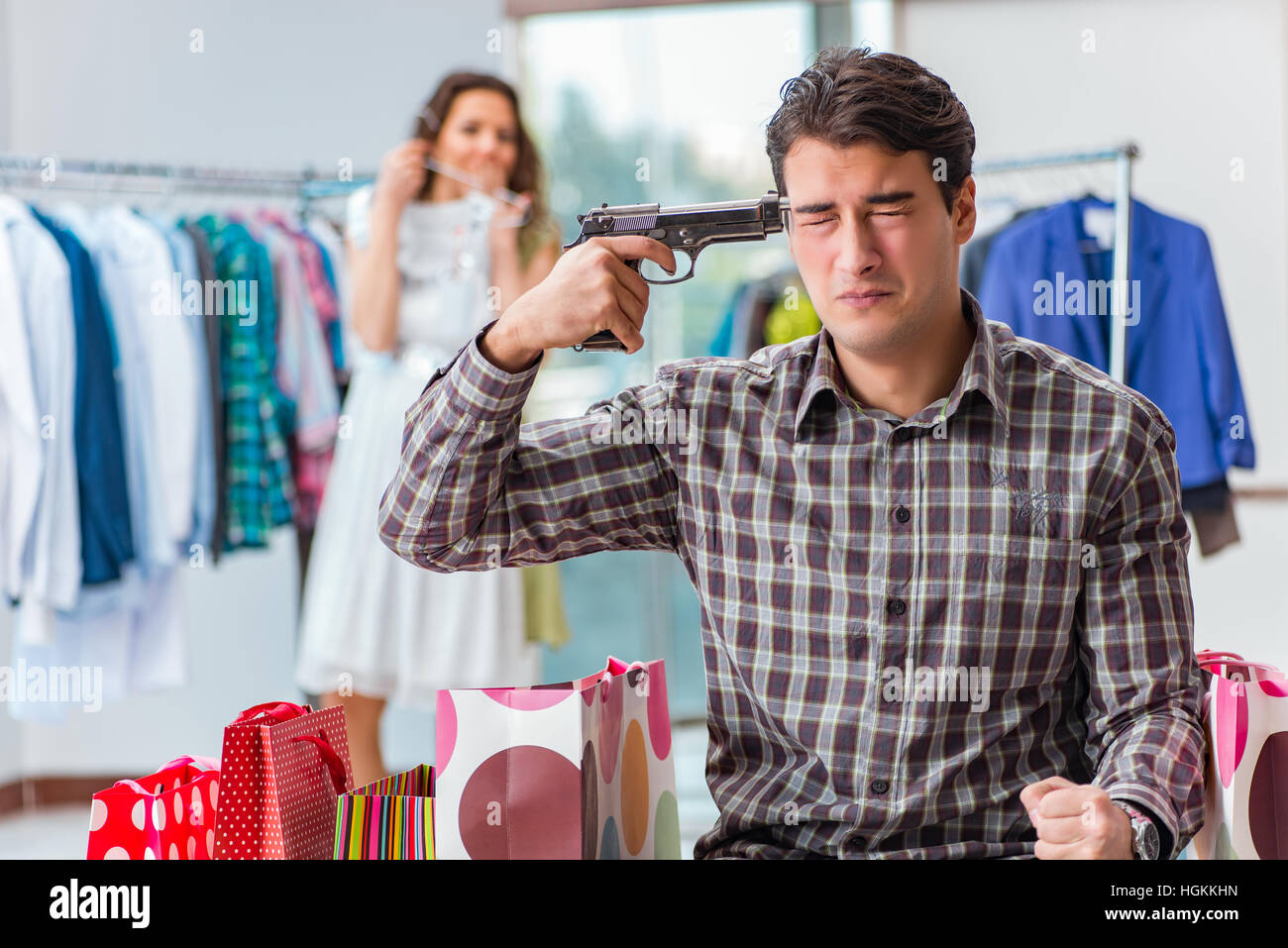 Man fed up with wife shopping in shop Stock Photo - Alamy