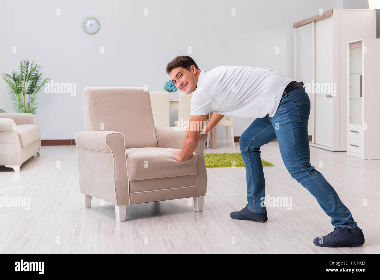 Man moving furniture at home Stock Photo - Alamy