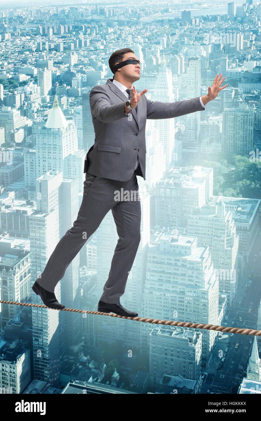 Man walking in tight rope blindfold Stock Photo - Alamy